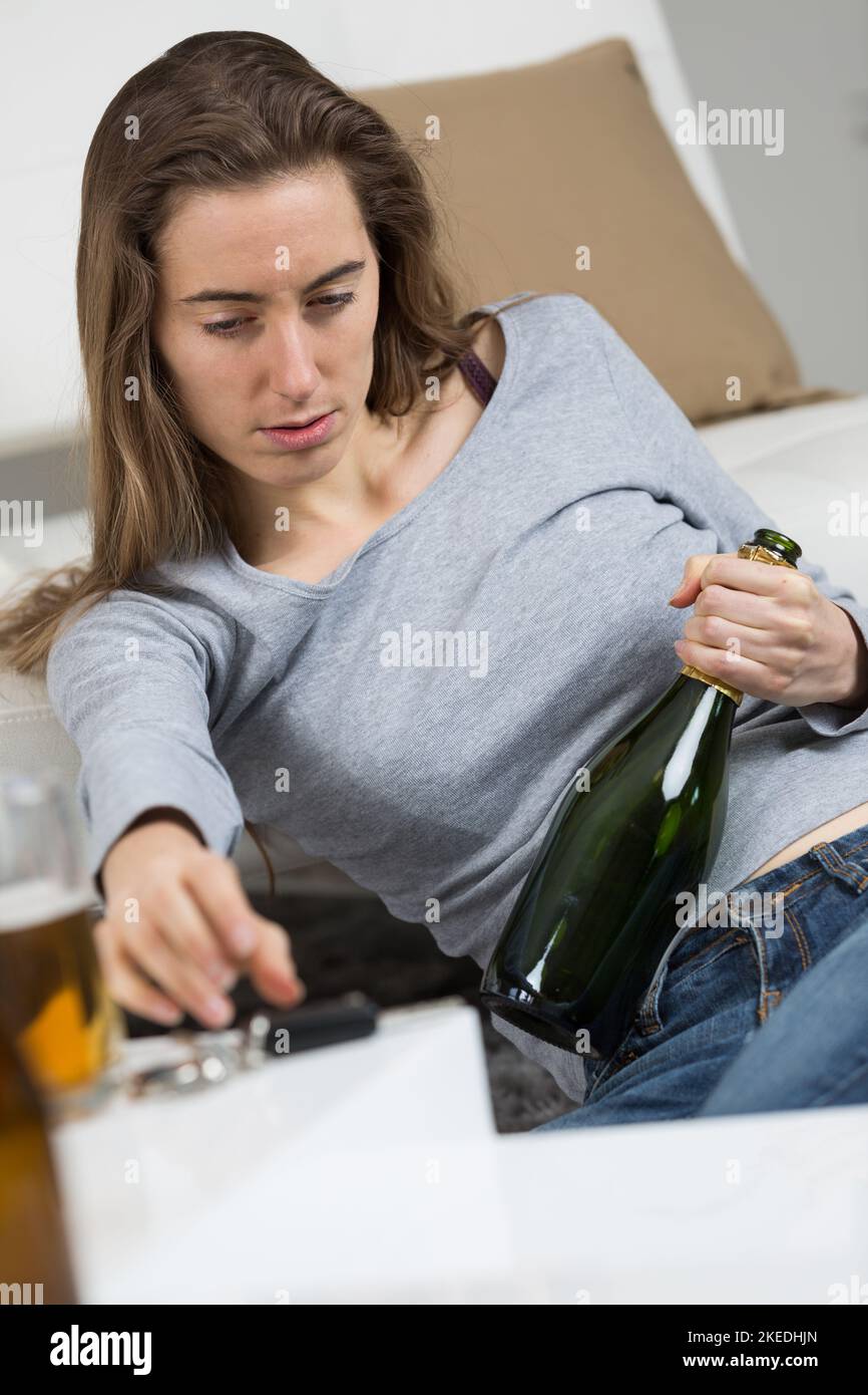 drunk girl holding bottle Stock Photo - Alamy