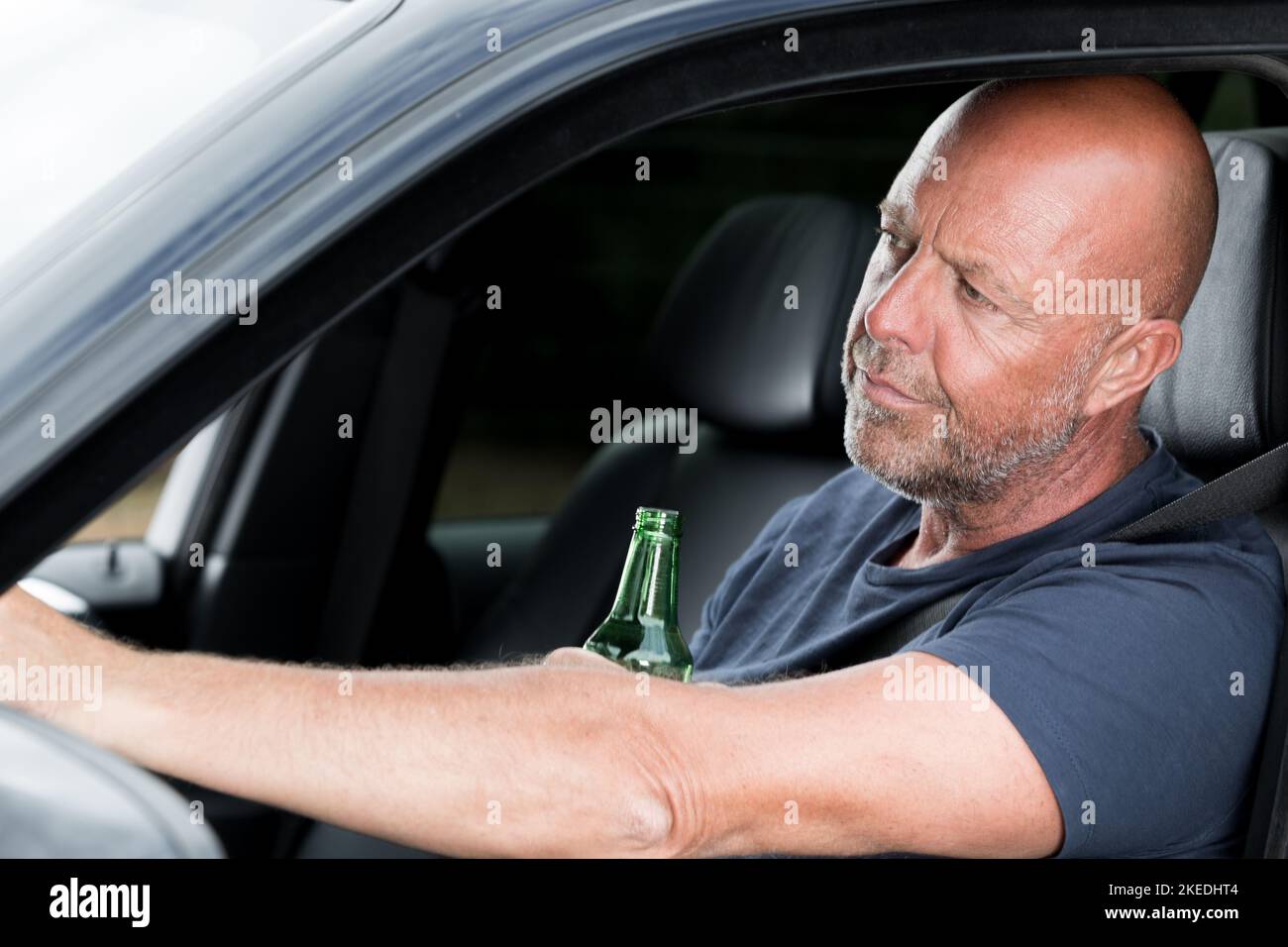 angry man drinking beer while driving a car Stock Photo - Alamy