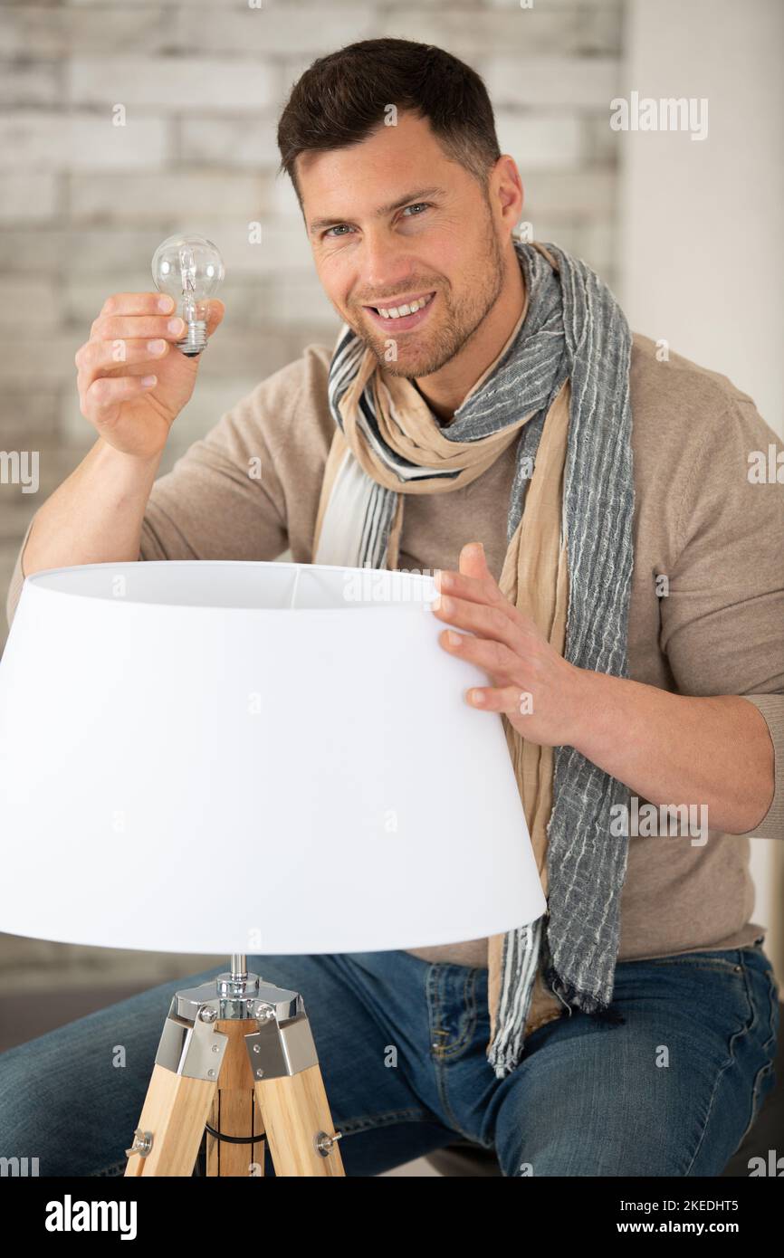 asian man changing light bulb Stock Photo - Alamy