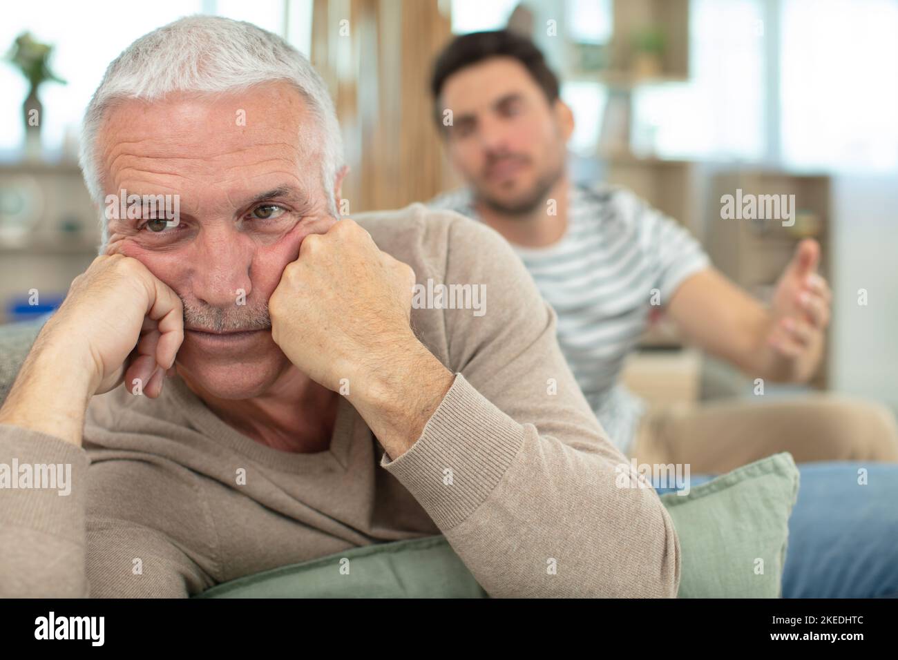 two men in living room have had an argument Stock Photo - Alamy