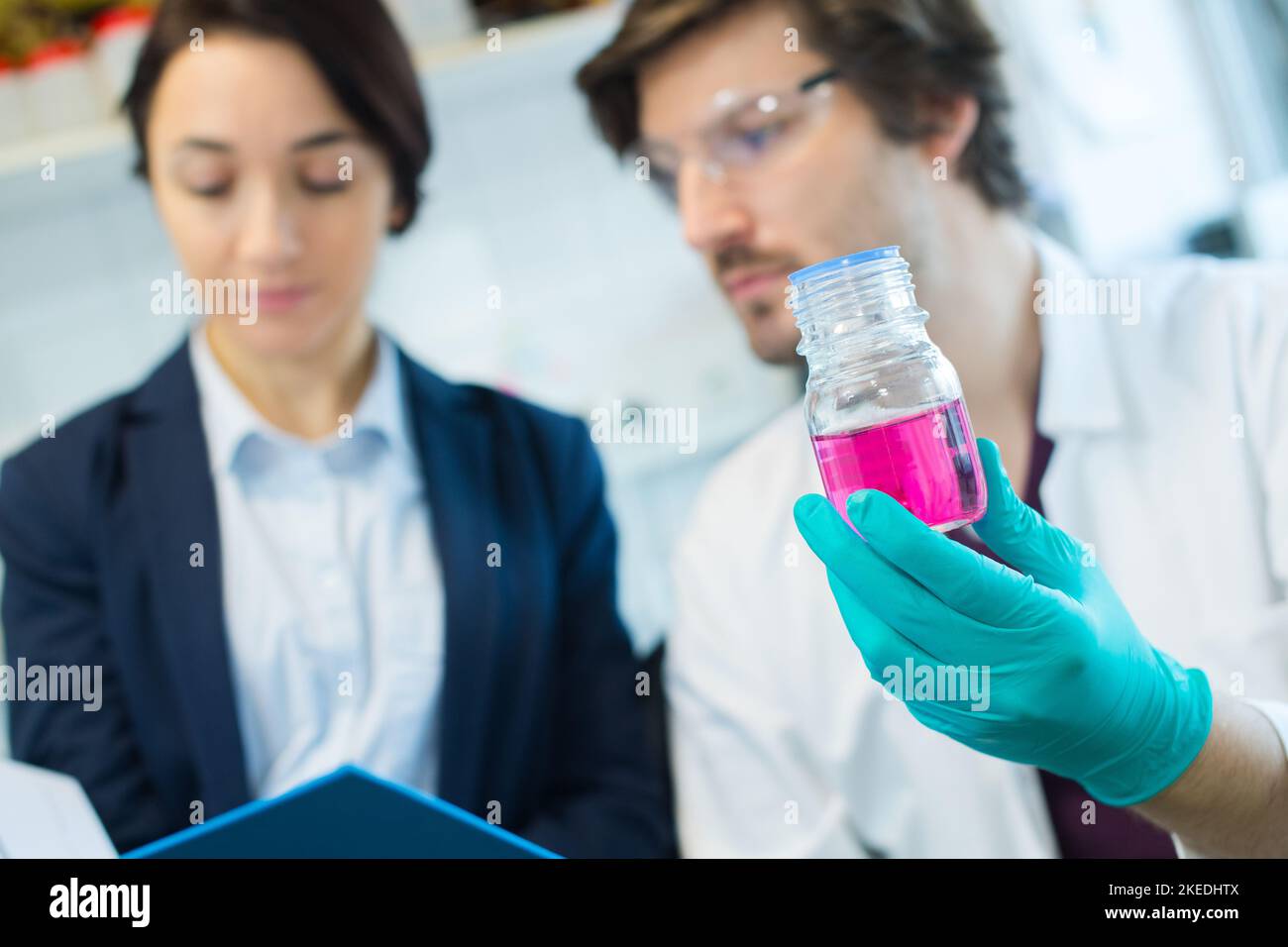 male lab worker making notes Stock Photo - Alamy
