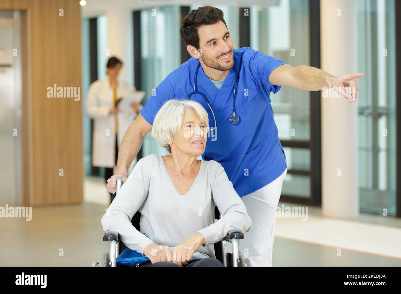 smiling senior citizen in wheelchair and nurse Stock Photo - Alamy