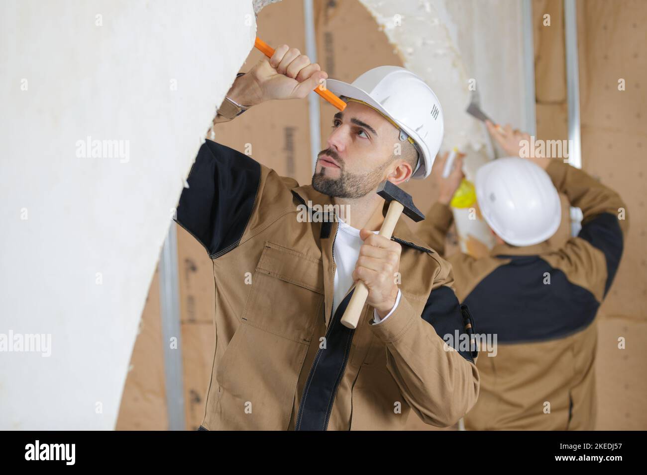 construction worker demolishing old wall with chisel tool Stock Photo ...