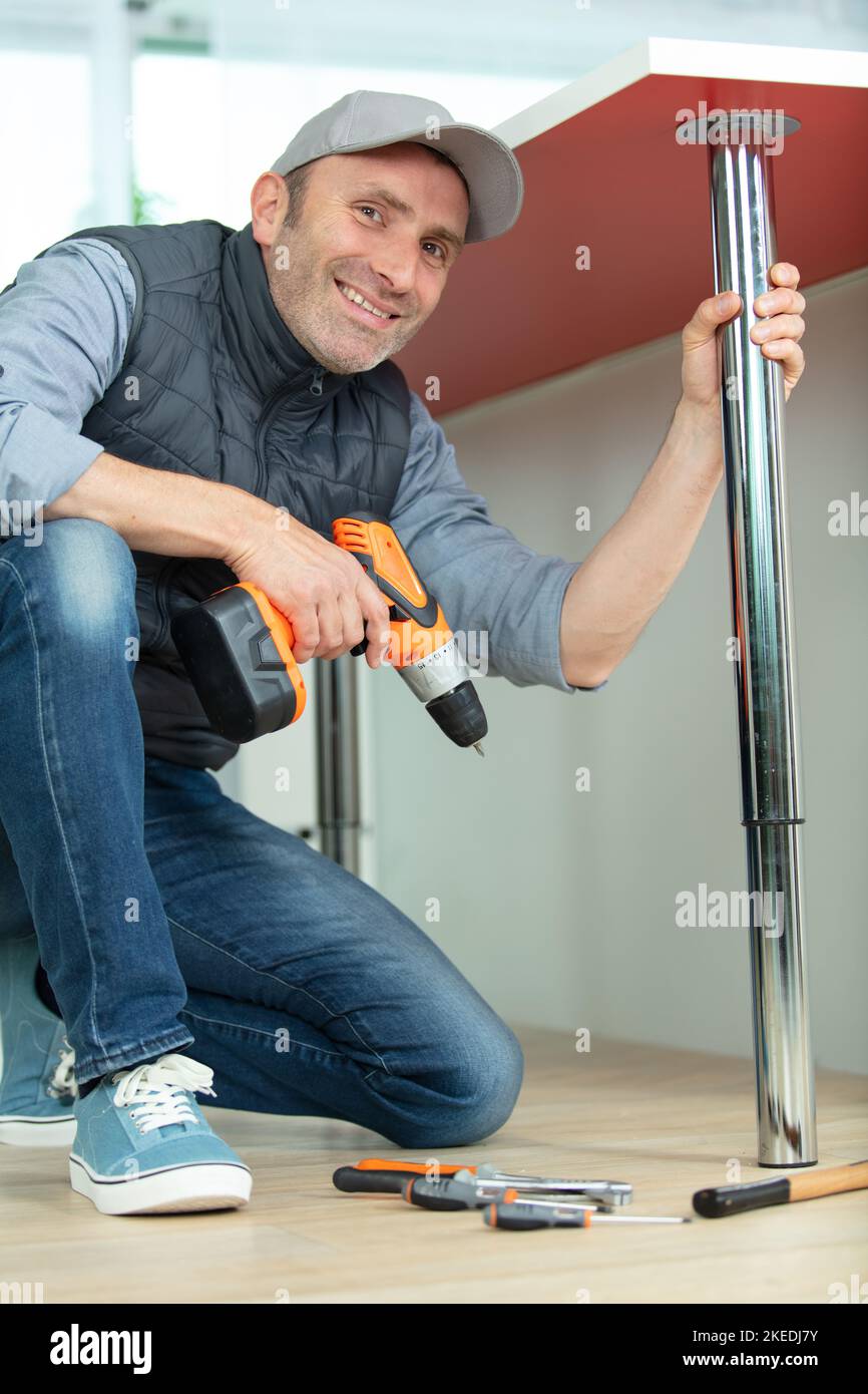 portrait of a carpenter posing against a background Stock Photo - Alamy