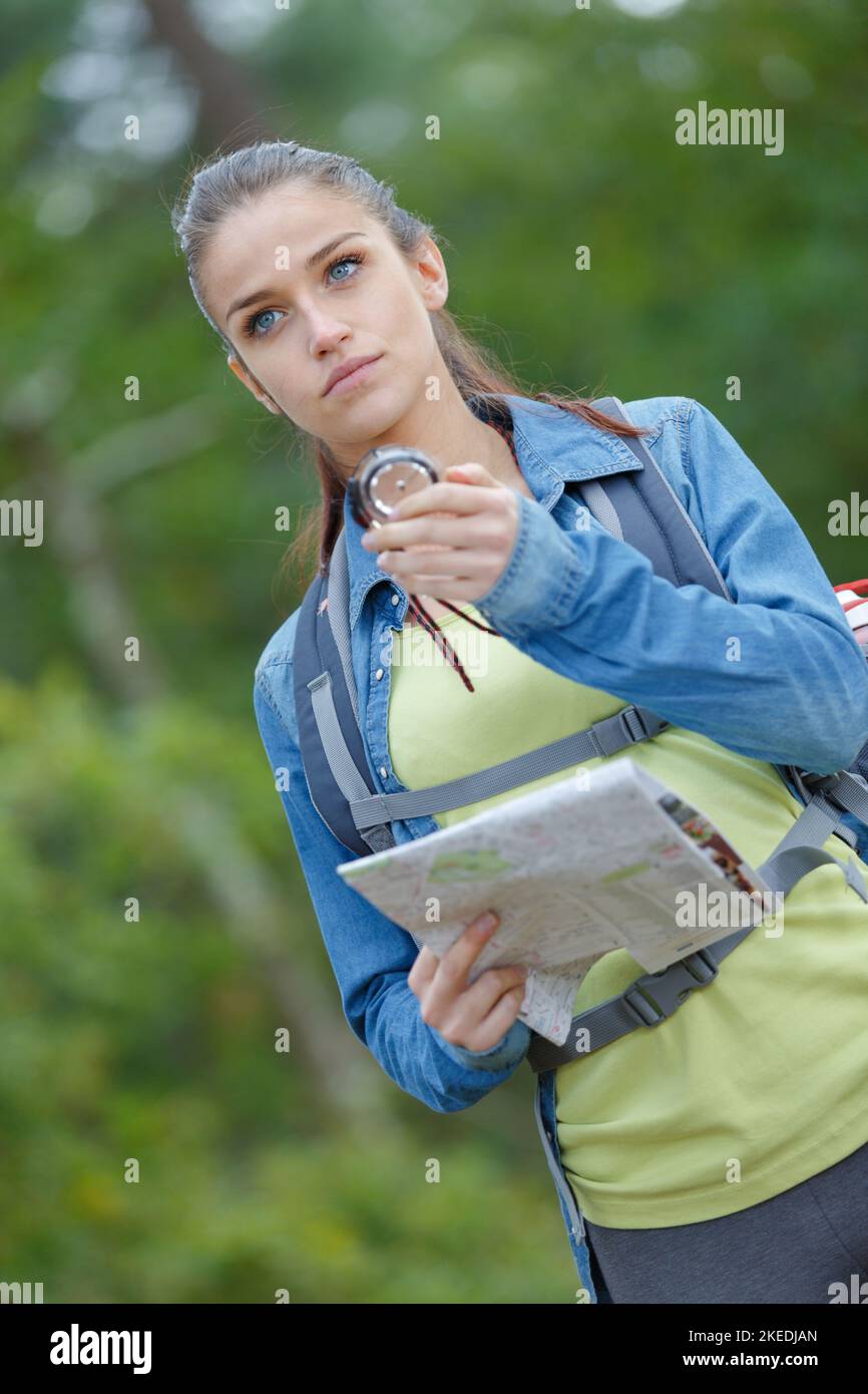 hiker with compass and reading map in the nature Stock Photo - Alamy