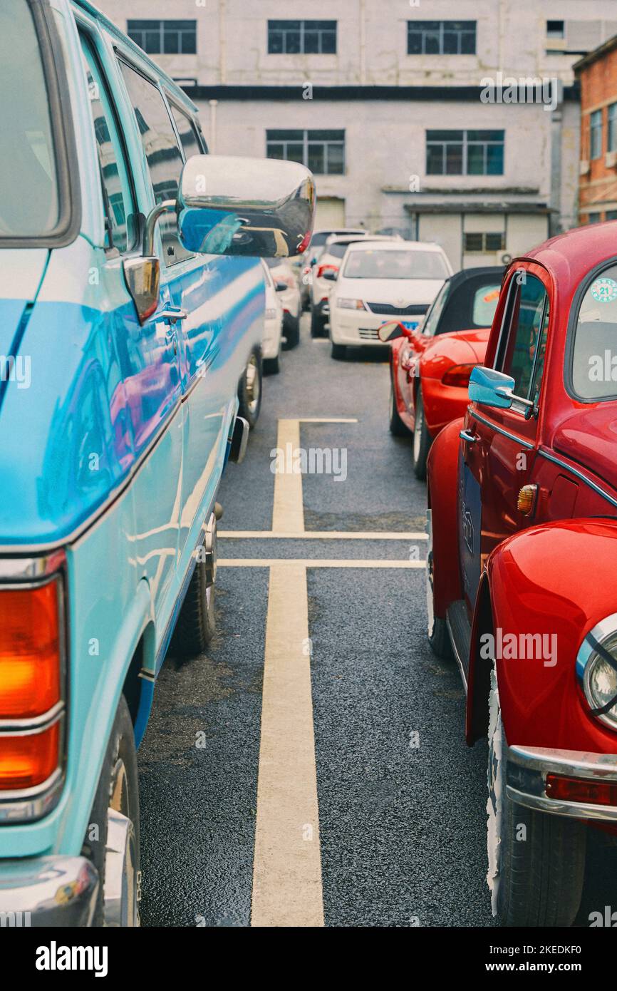 A narrow space between vintage cars parks in a car market Stock Photo ...