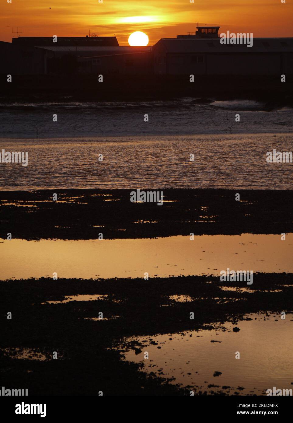 Sunset behind Brighton City Airport with the Adur at low tide. Ricardo ...