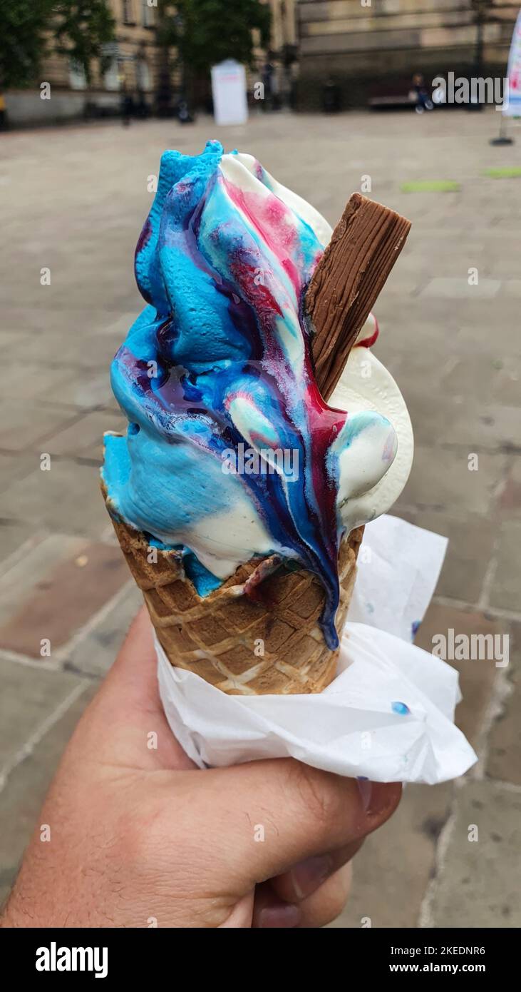 A vertical shot of a person holding a delicious ice cream cone Stock ...