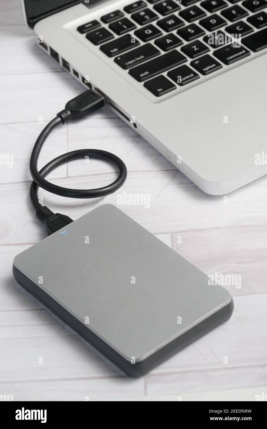 working at office, laptop on the table connected USB Cable with ...