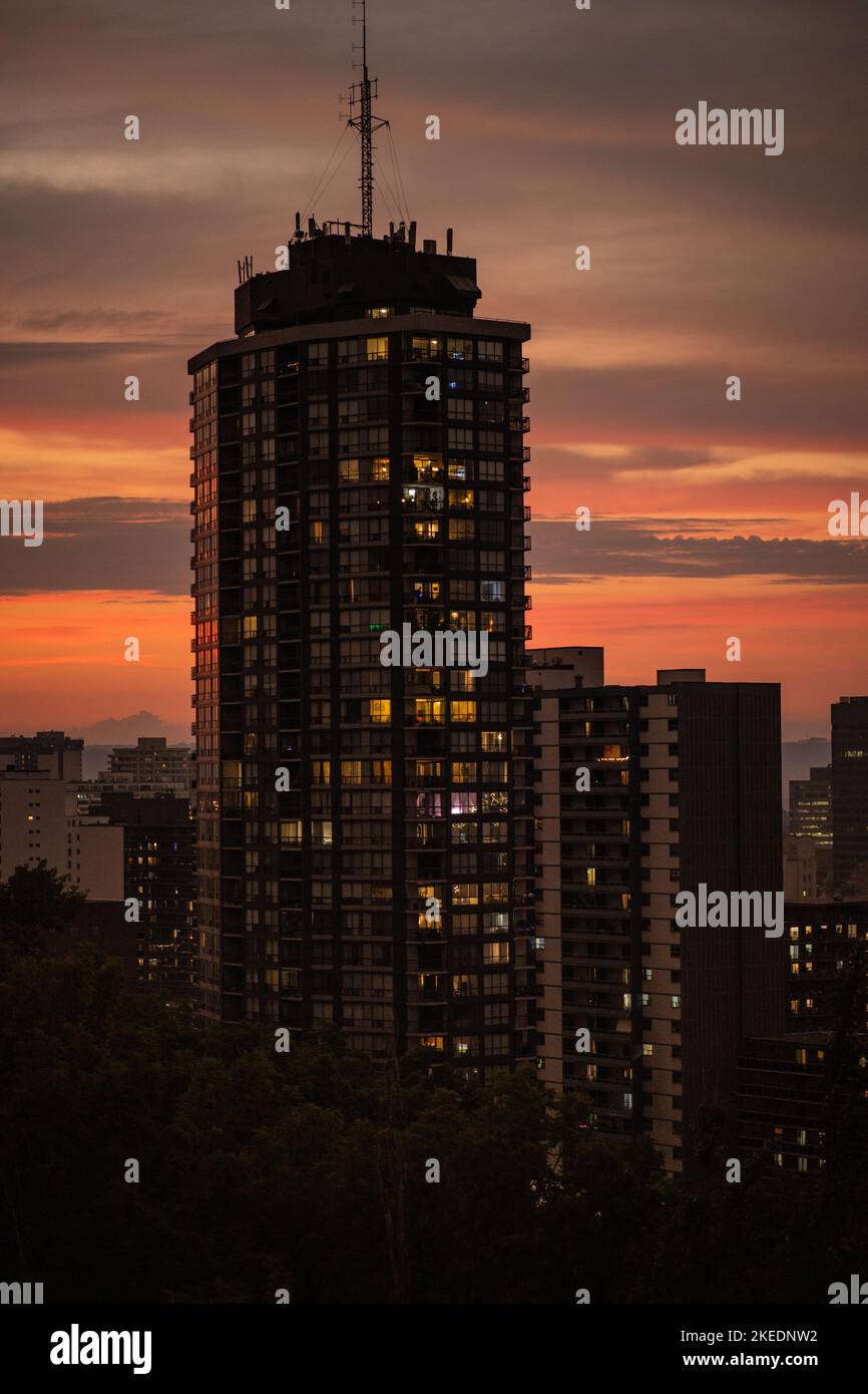 A vertical shot of a tall residential building at sunset in Hamilton ...