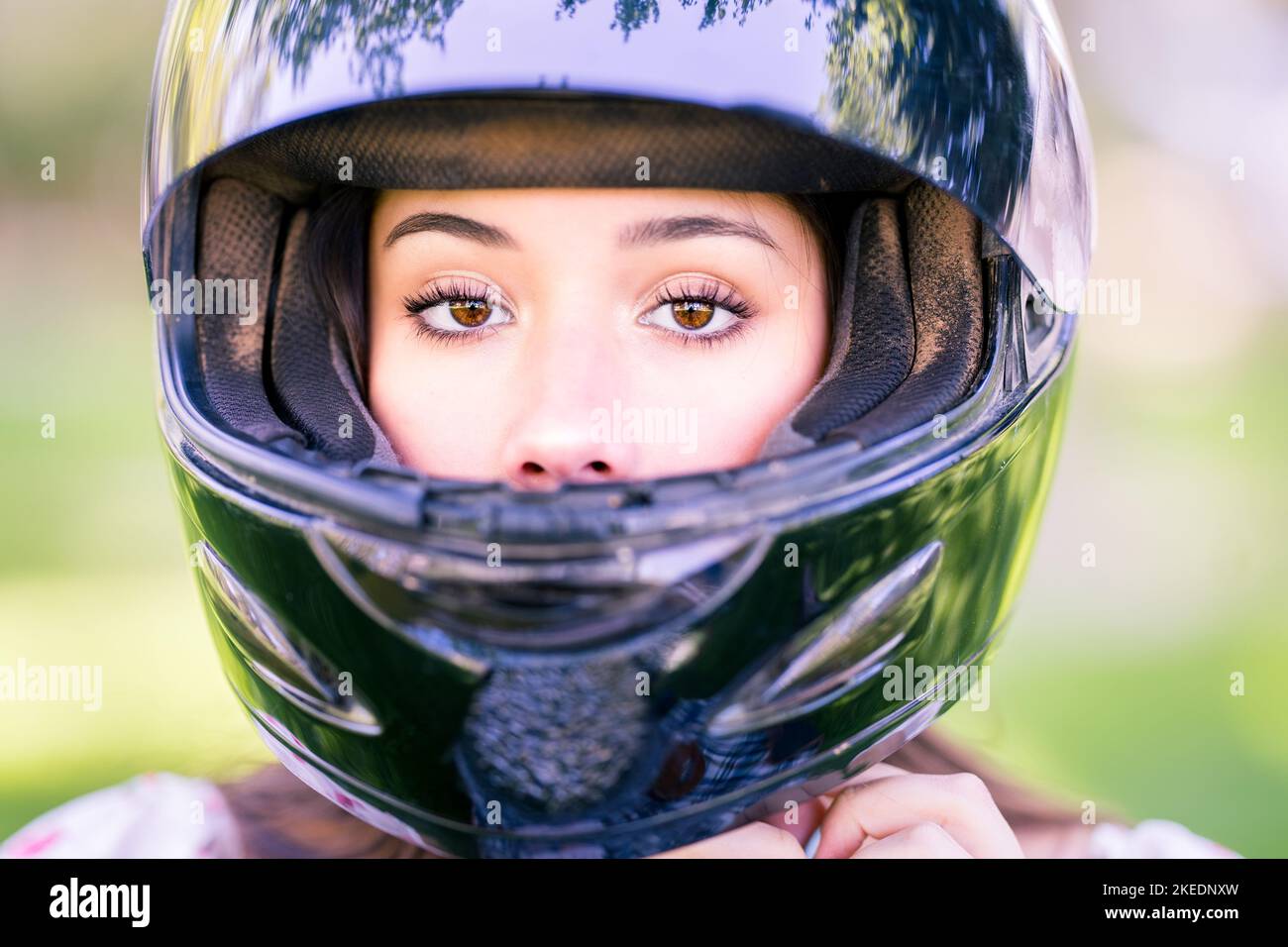 Close Up on the Eyes of Teenage Female Adjusting Dirt Bike Helmet ...