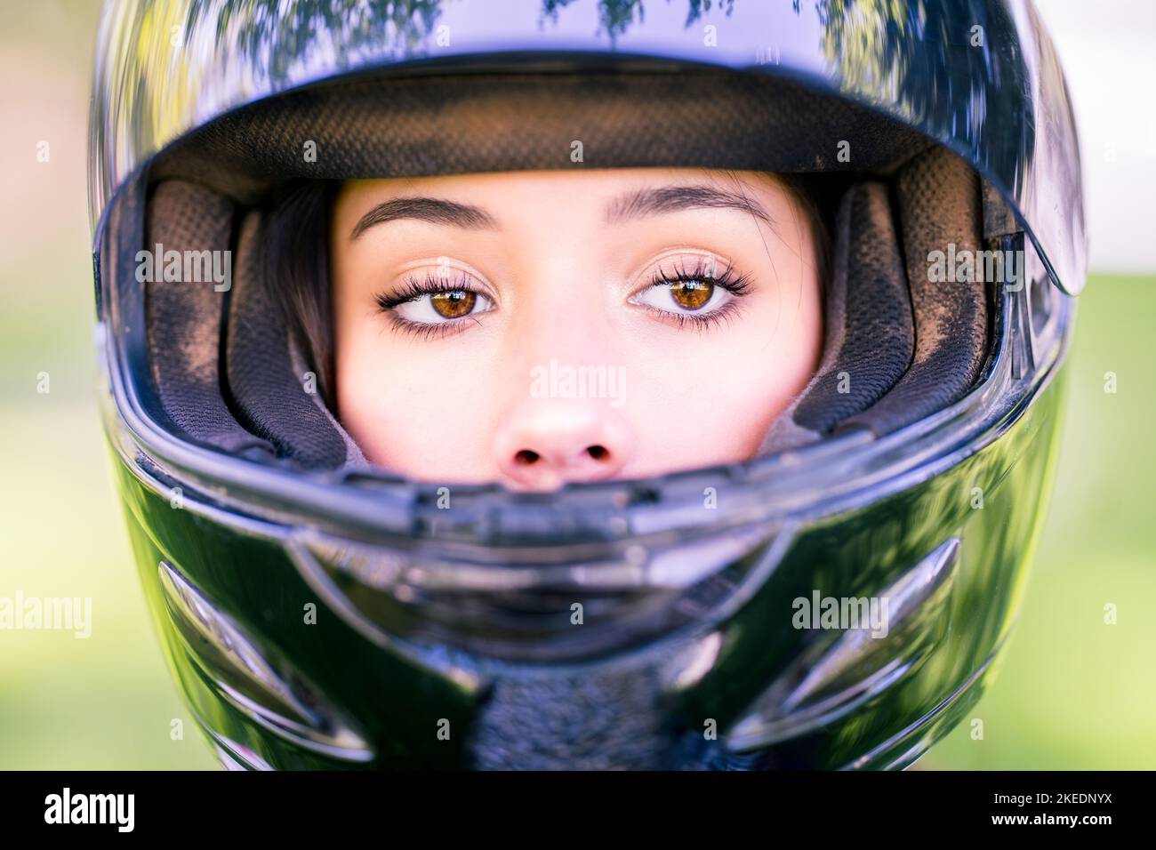 Close Up on the Eyes of Teenage Female Adjusting Dirt Bike Helmet ...