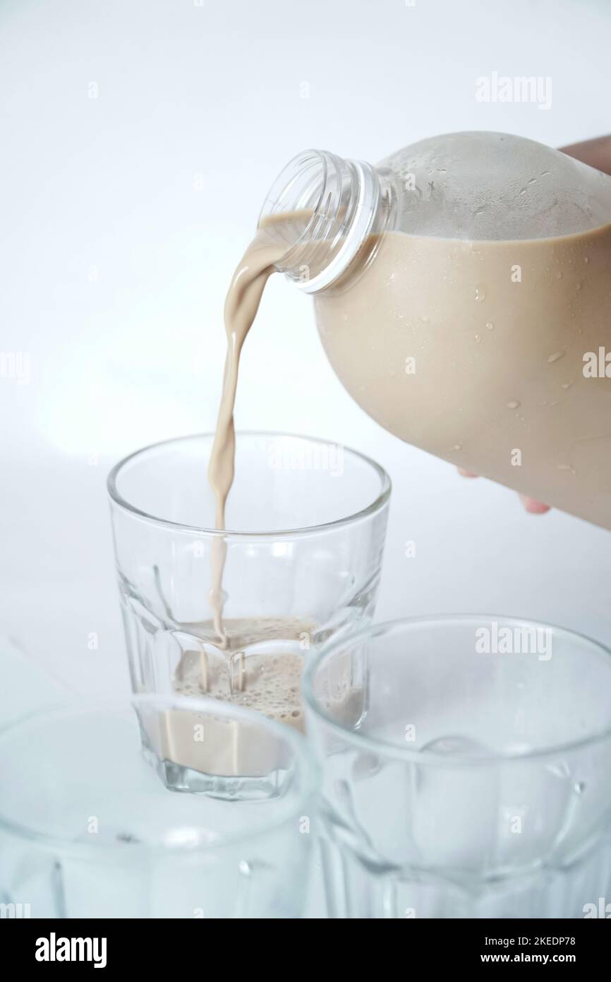 pouring chocolate milk into a glass Stock Photo - Alamy