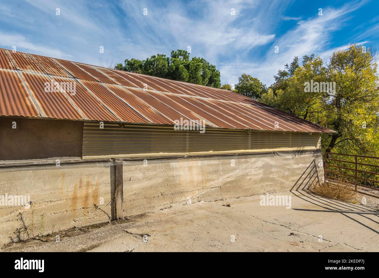 A rusted metal roof with dramatic sky, deep blue with whispy clouds in ...