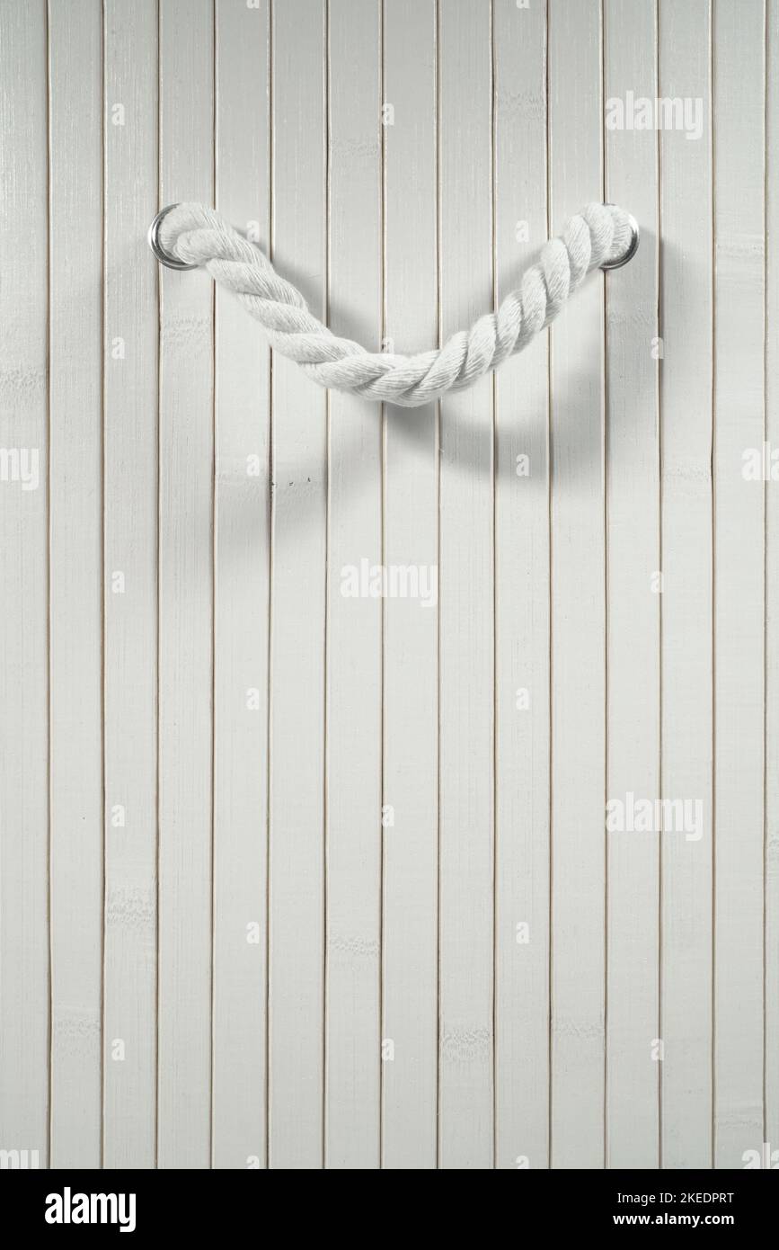 Wooden background with white boards and nice handles made of thick rope ...