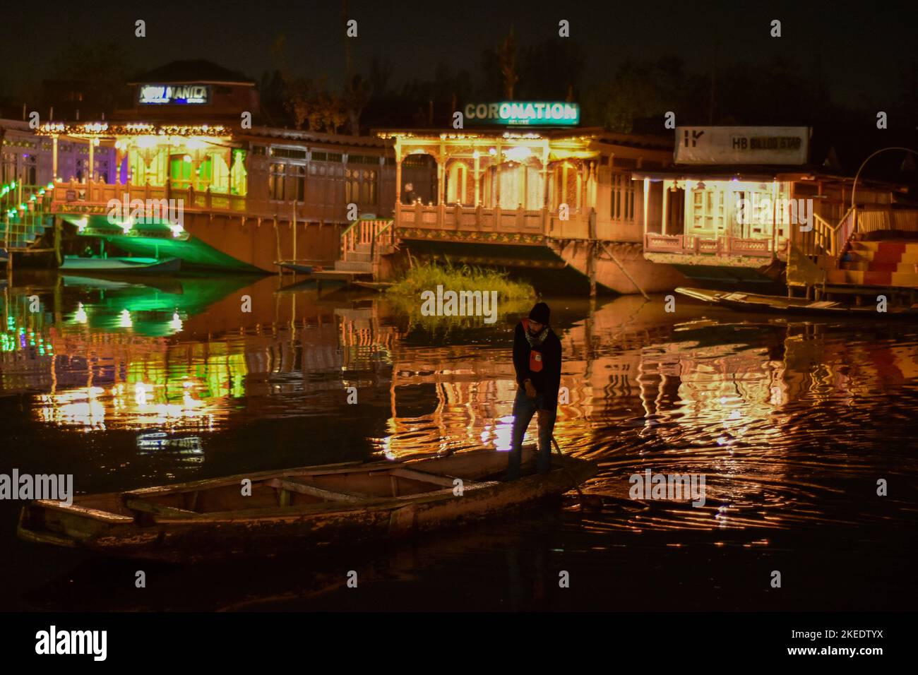 Srinagar, India. 11th Nov, 2022. A man rows his boat across the world famous Dal lake during a ...