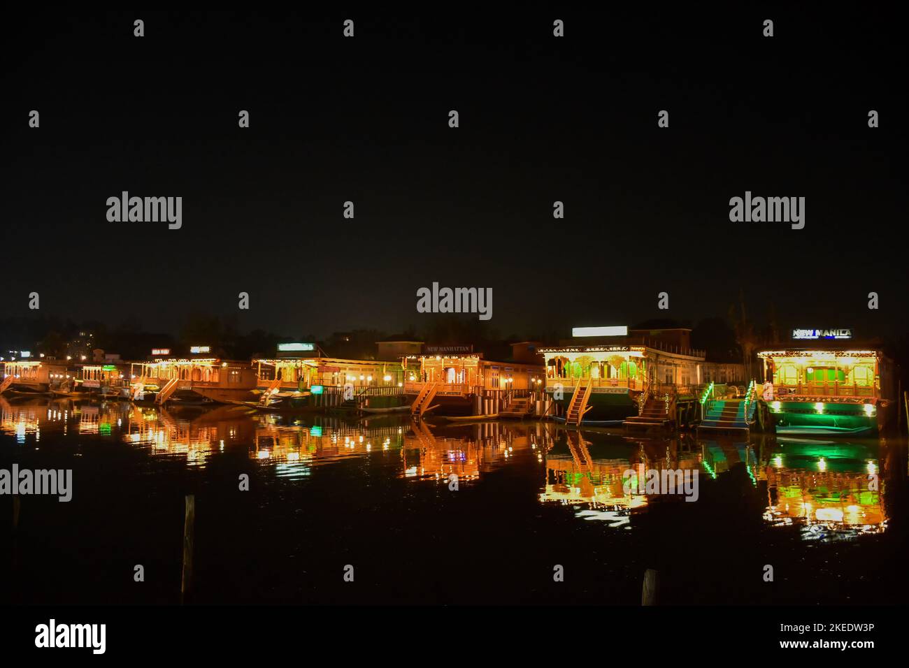 A late night view of the illuminated floating houseboats on Dal lake in ...