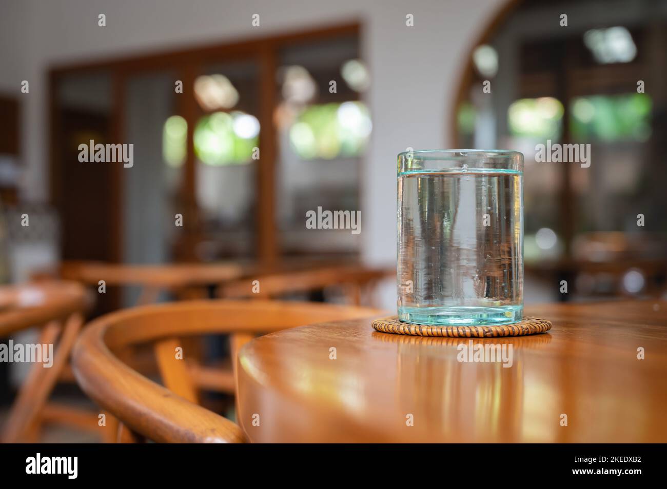 Glass of water in cafe. Beautiful interior of Bali style cafe in Ubud ...