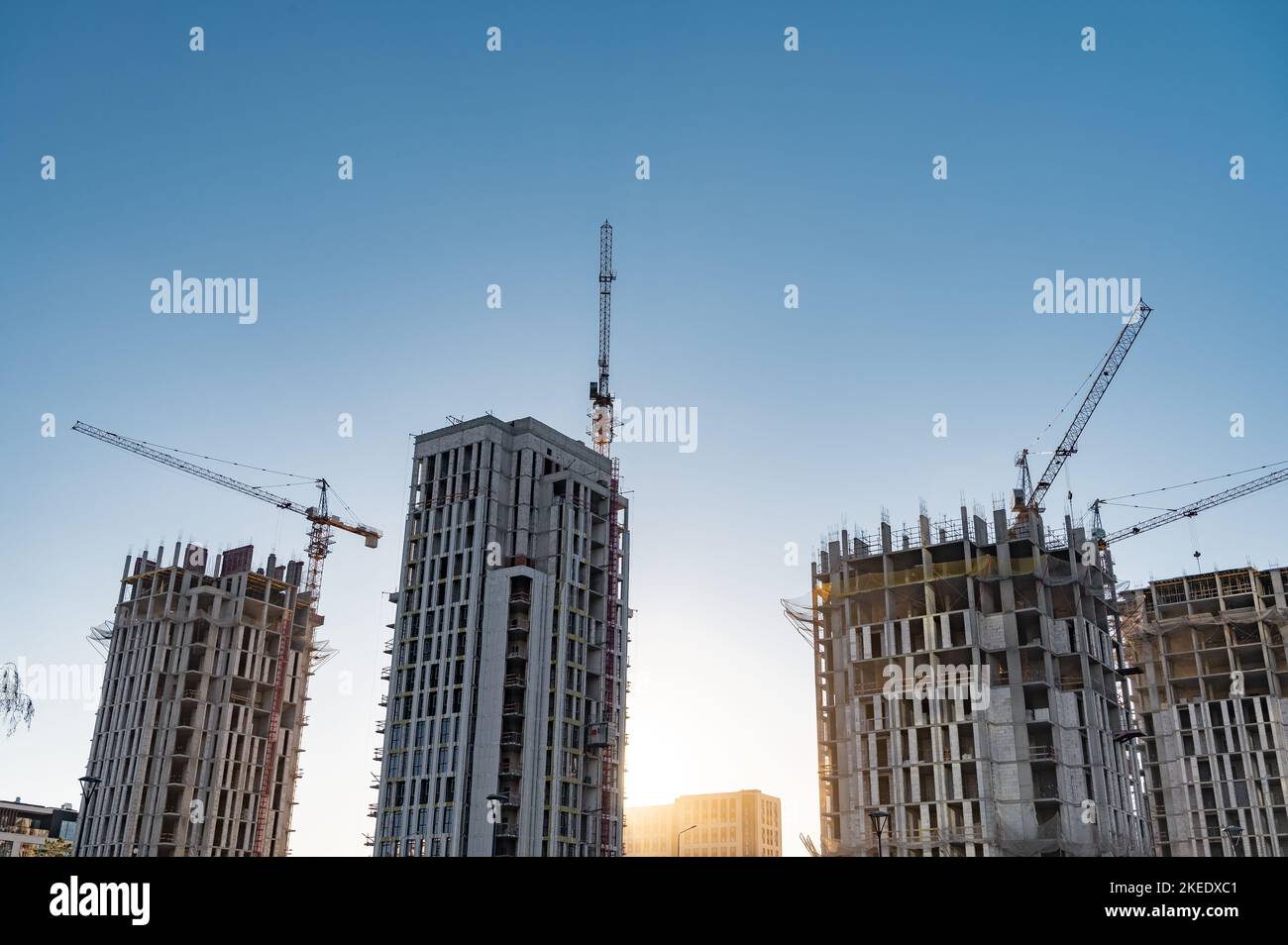 Tall buildings under construction and cranes under a blue sky Stock ...