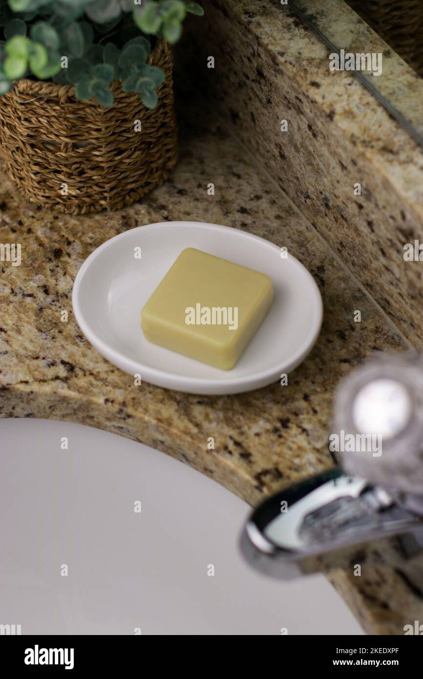 a bar of zero waste soap on white dish at bathroom sink Stock Photo - Alamy