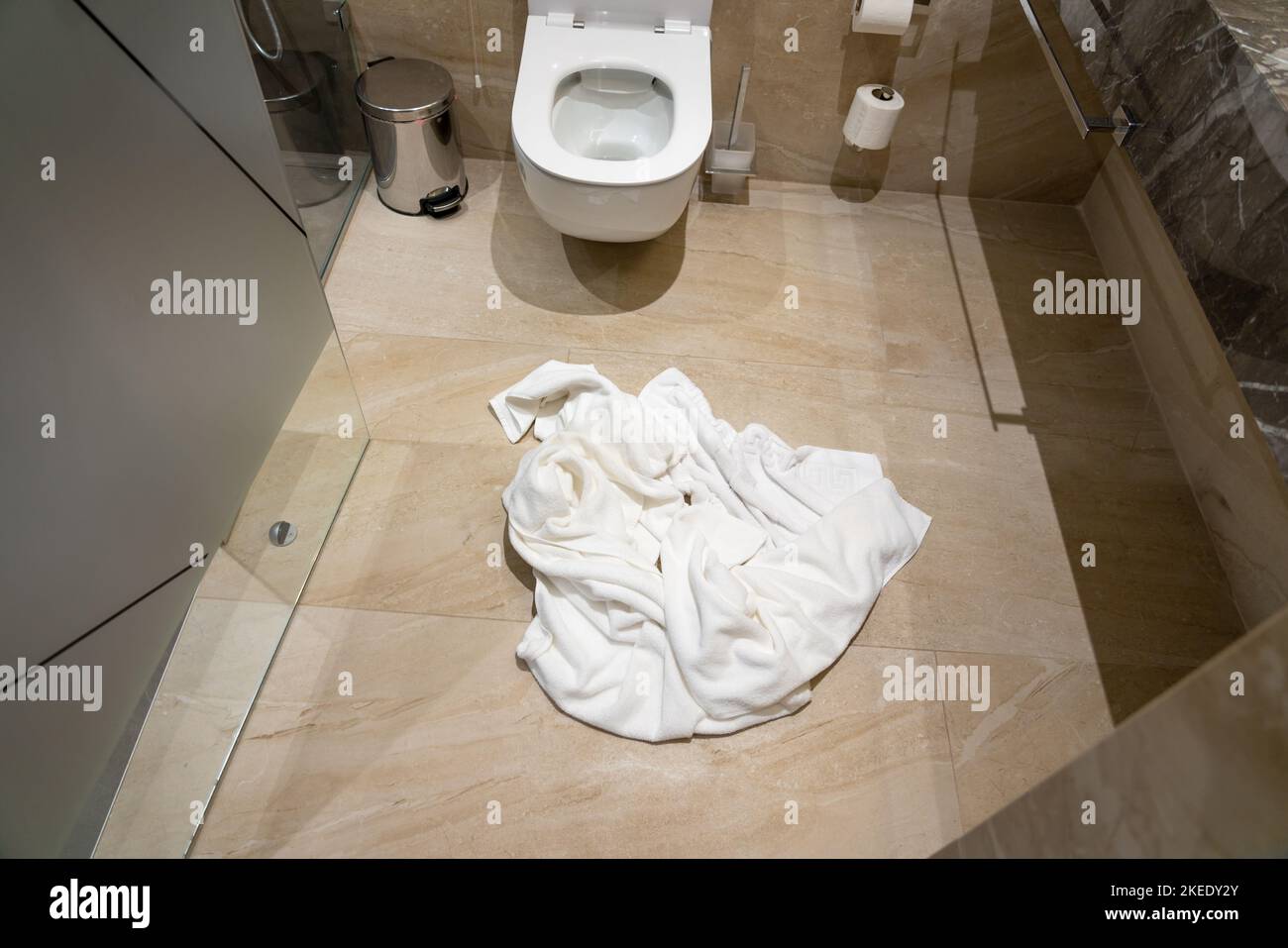Pile of crumpled used towels on the bathroom floor Stock Photo - Alamy