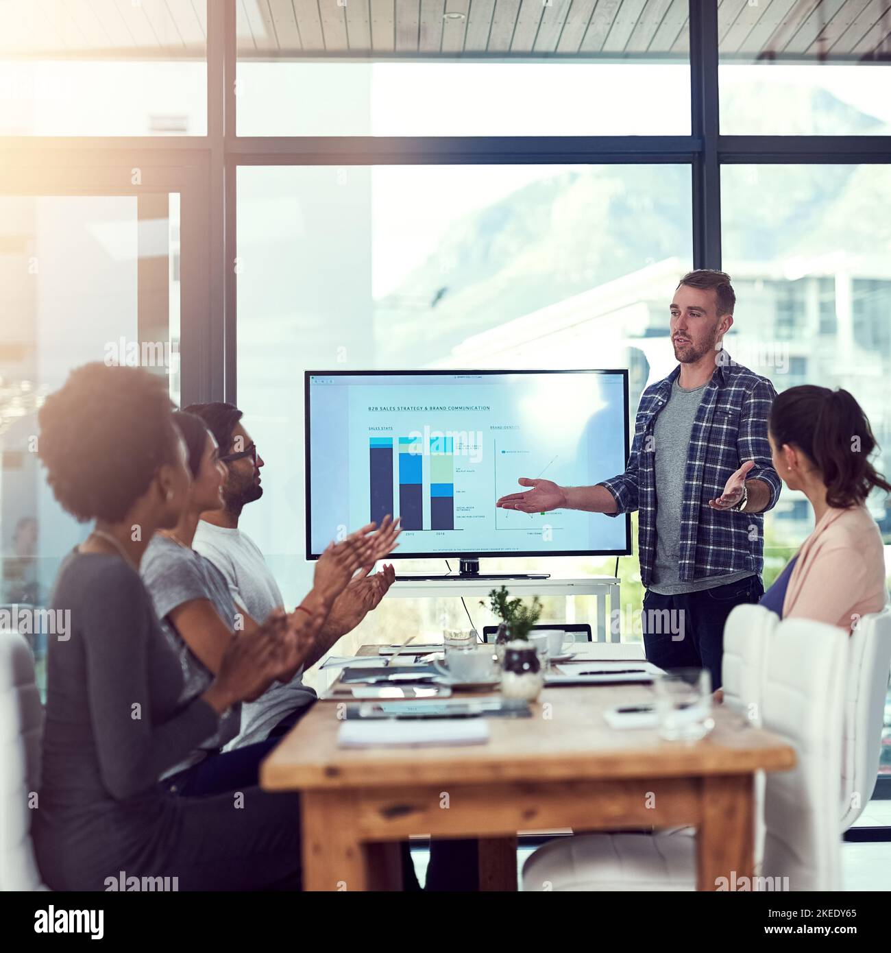 You can ask me anything. a young man giving a presentation to his team ...
