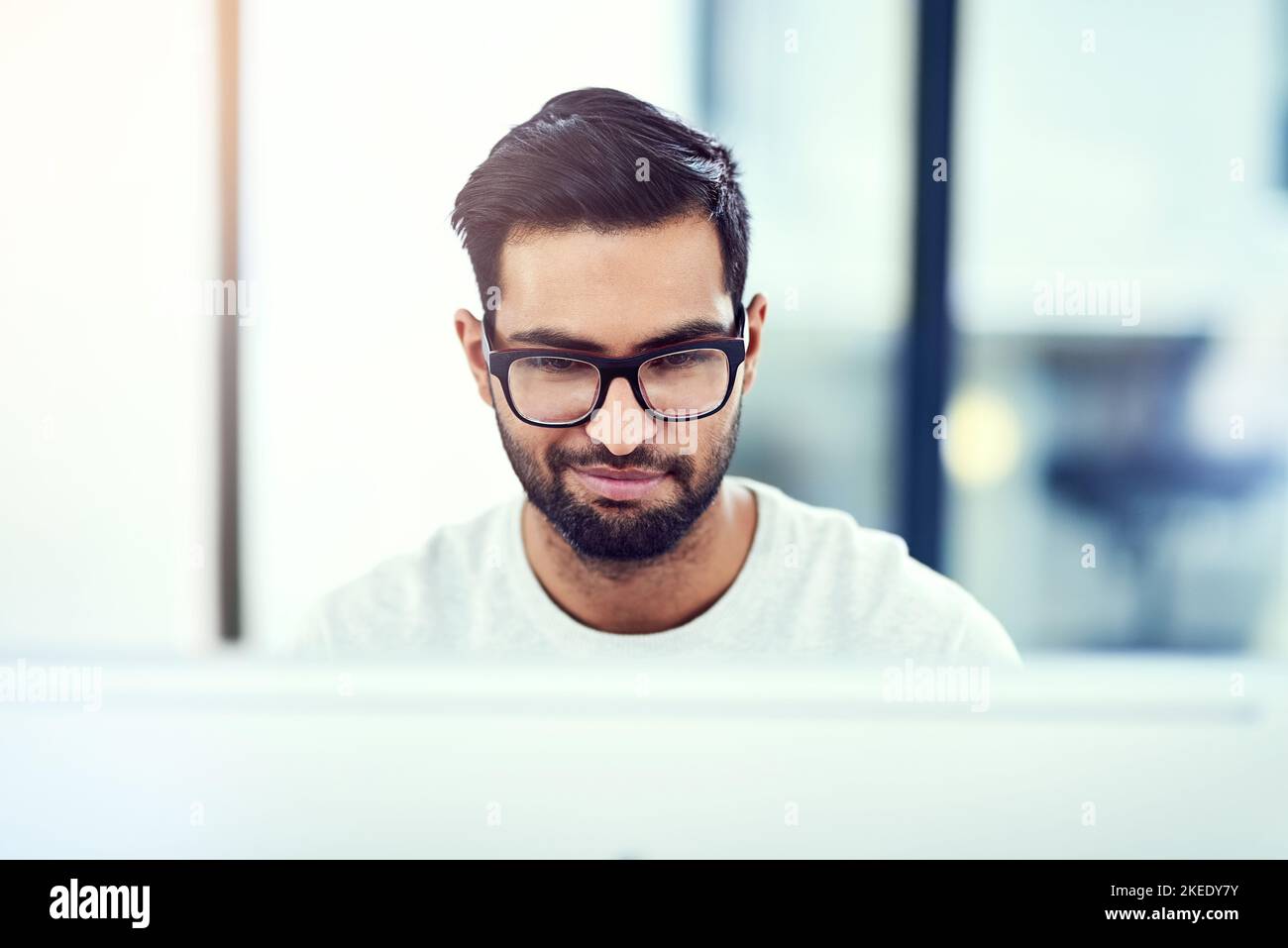 Feeling chuffed. a young man working in his office Stock Photo - Alamy