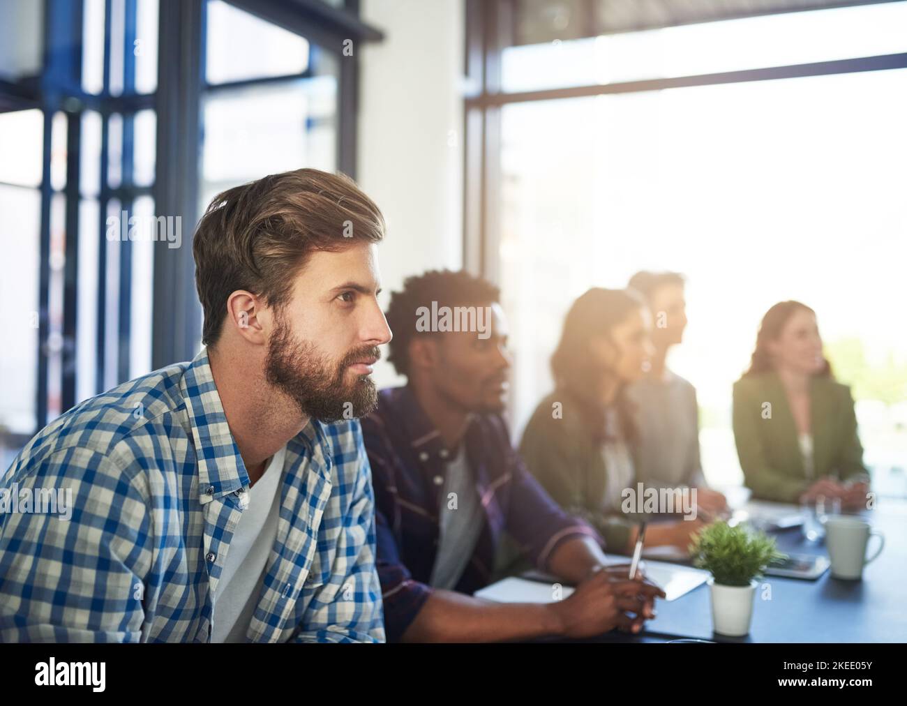 They share a common vision for success. a group of colleagues sitting ...