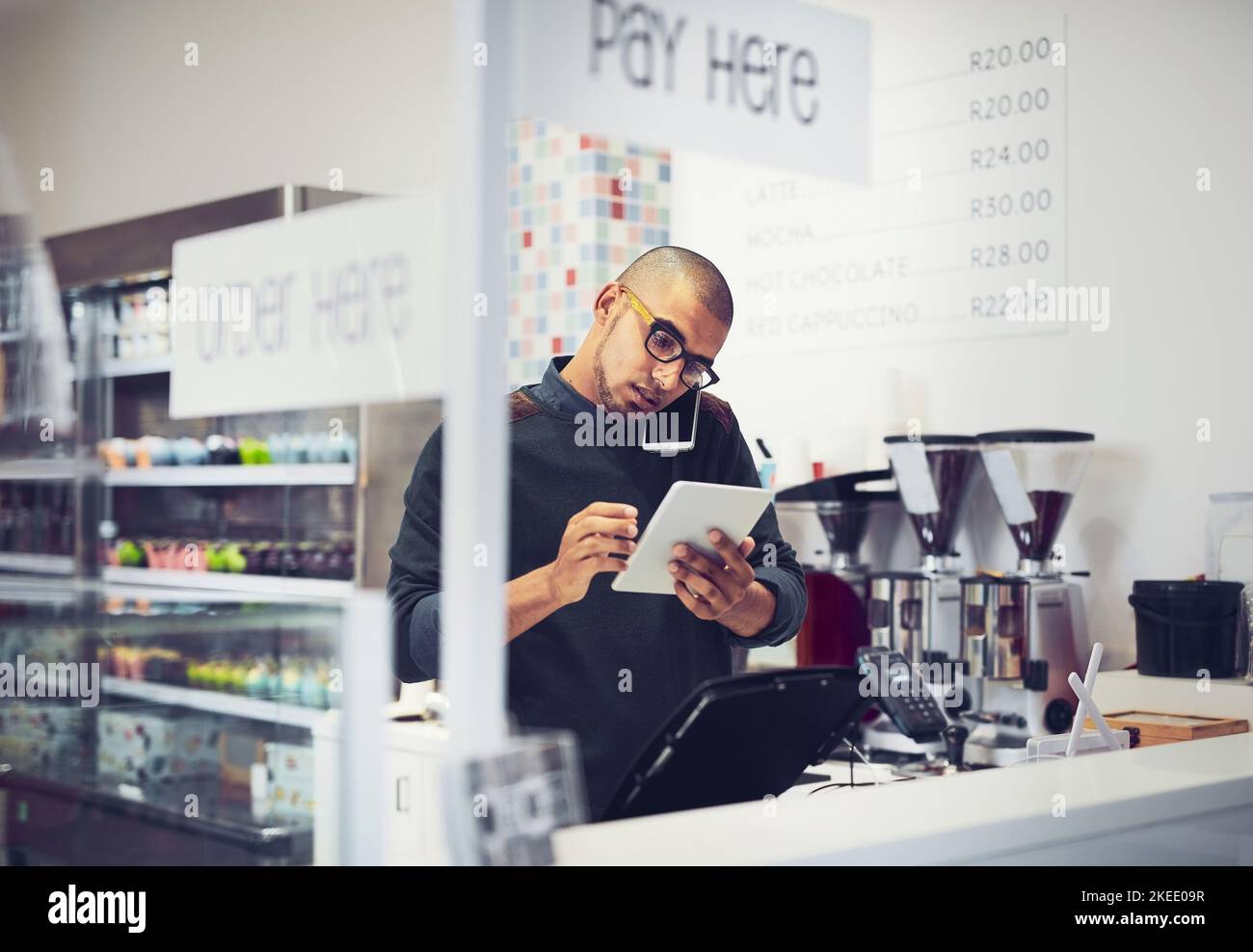 Ordering everything he needs to make great coffee. a man talking on his ...