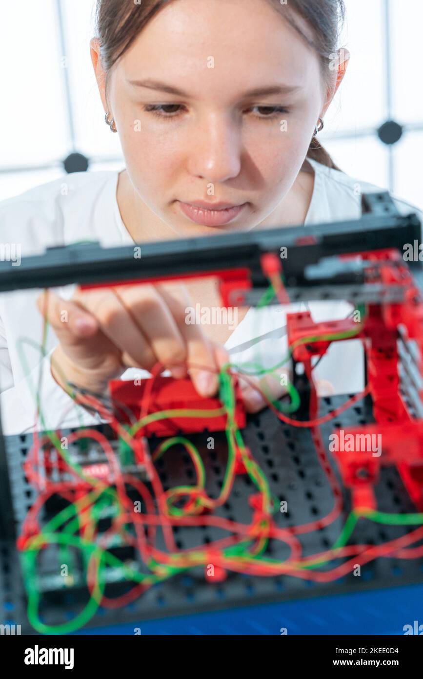 girl student in the electronics class designs a computer-controlled ...