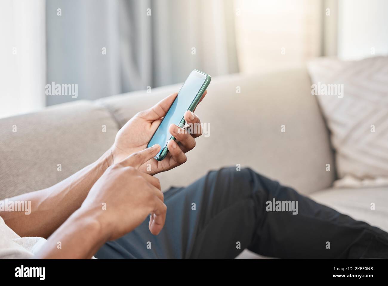 Mobile phone, communication and 5g network, man on living room couch ...