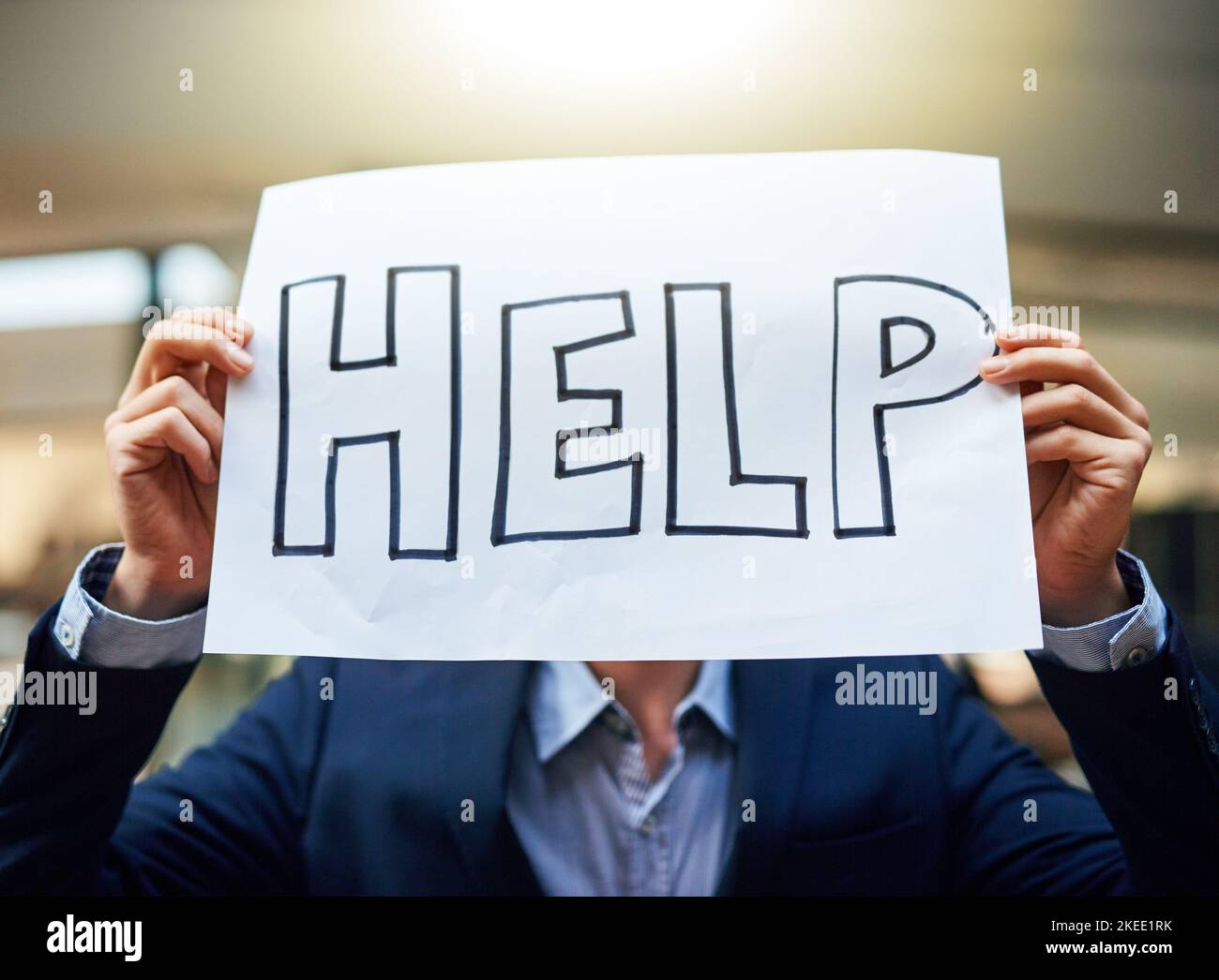 Everyone needs a bit of help sometimes. a businessman holding up a sign ...