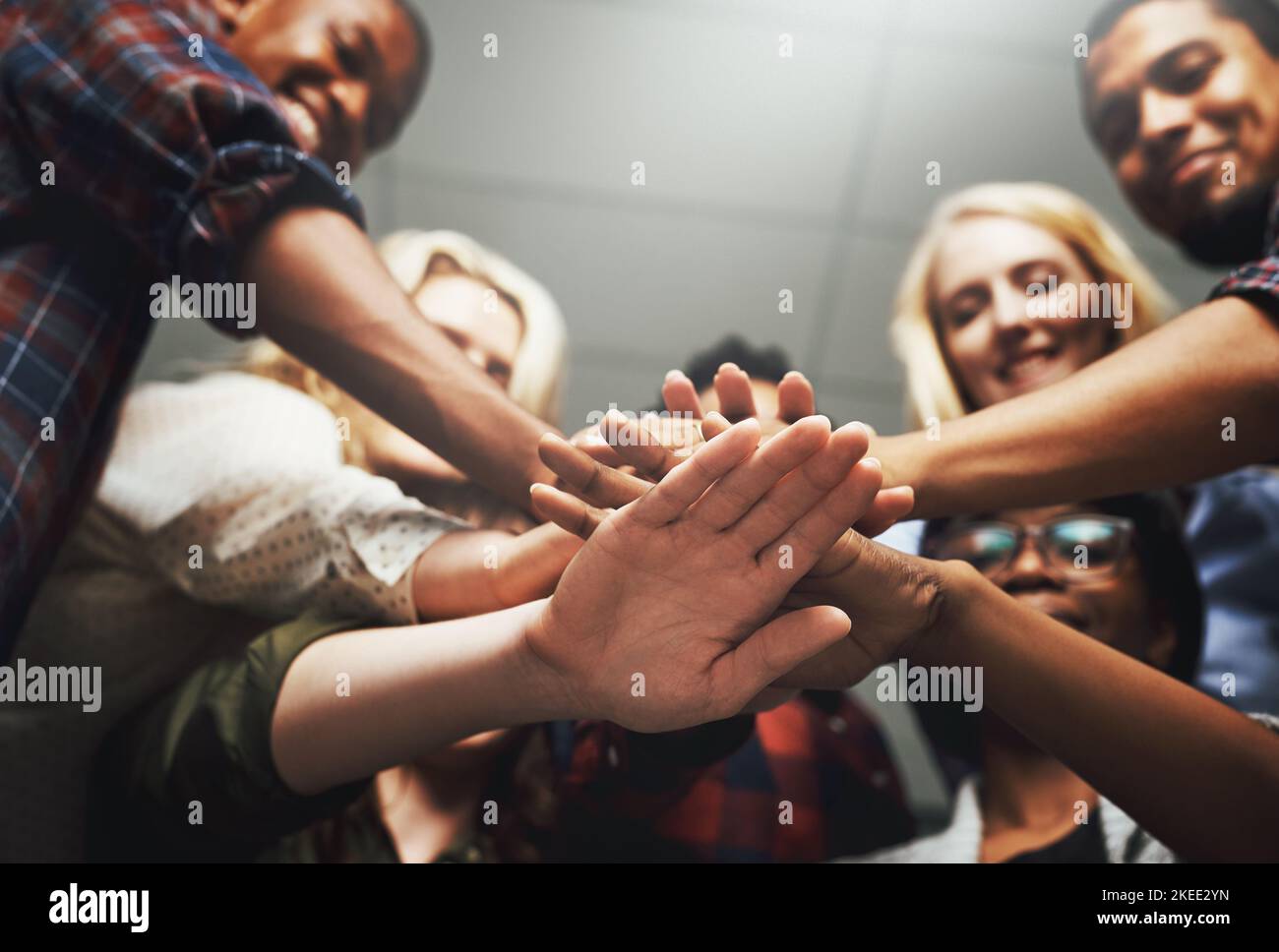 We got this. a group of cheerful work colleagues forming a huddle ...