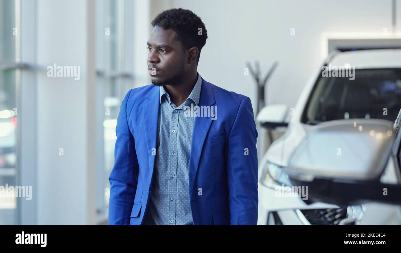 African American man explores automobile salon searching car Stock ...