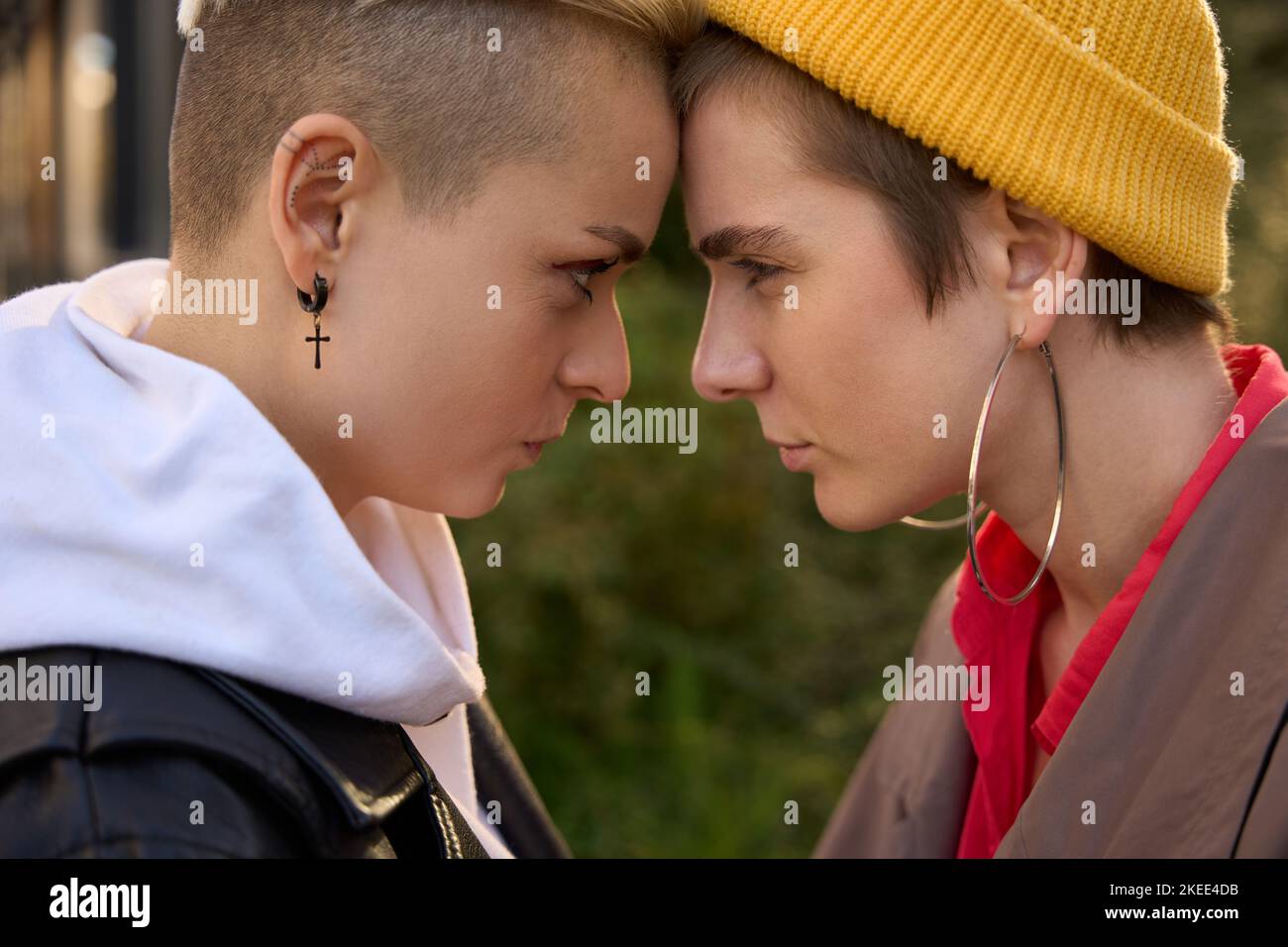 Two young women touch foreheads and look into each other's eyes Stock ...