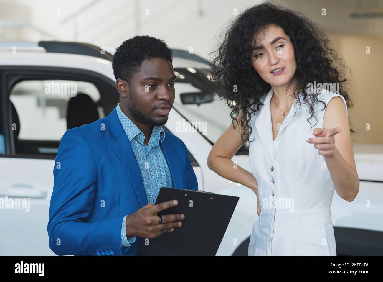 African American salesman listens to female customer desires Stock ...
