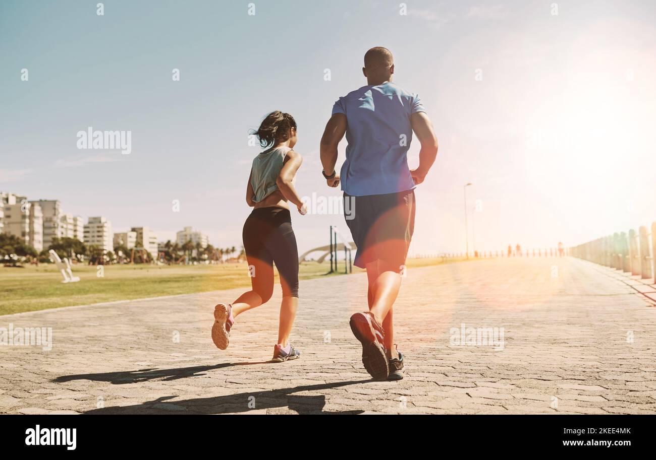 Just keep pushing on. a young sporty couple out for a run together ...