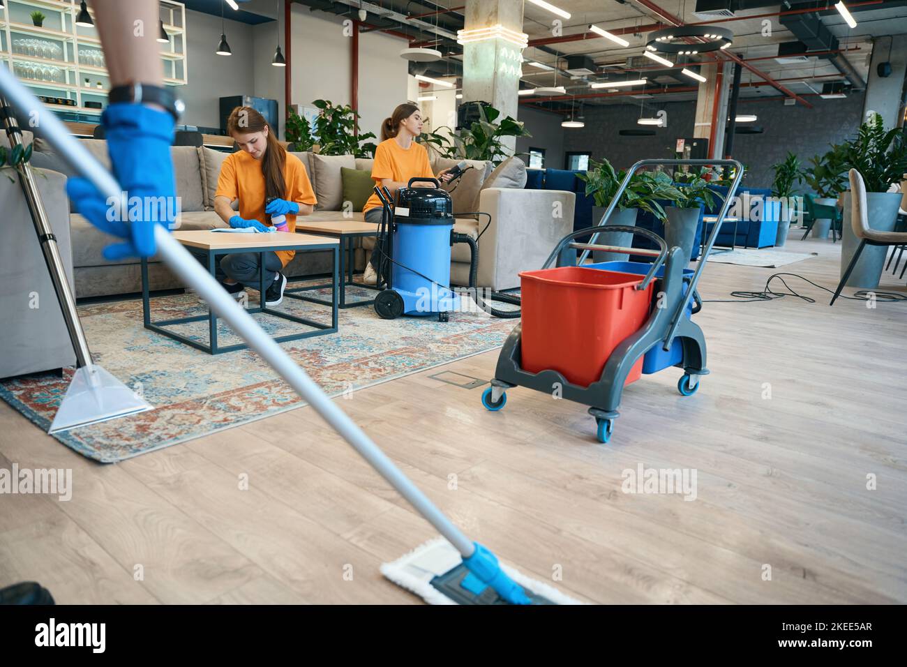 Cleaning in the coworking area, workers use a vacuum cleaner Stock ...