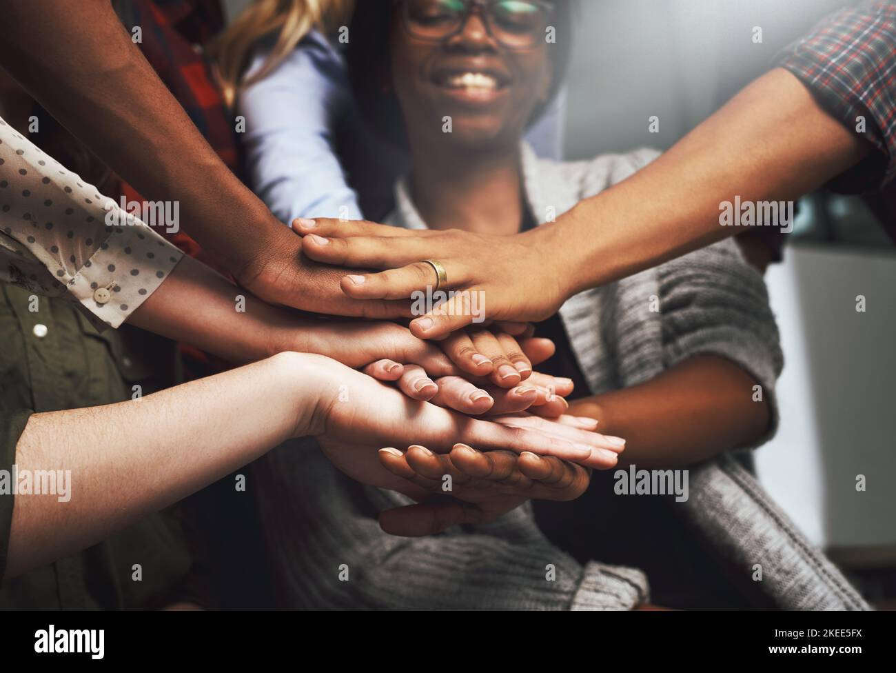 Together were unstoppable. a group of cheerful work colleagues forming ...