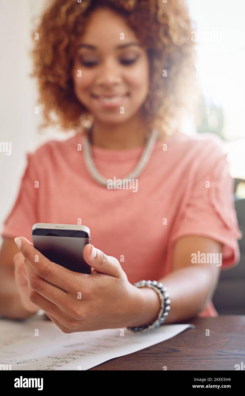 Creating a app to meet your needs. a designer using her cellphone at ...