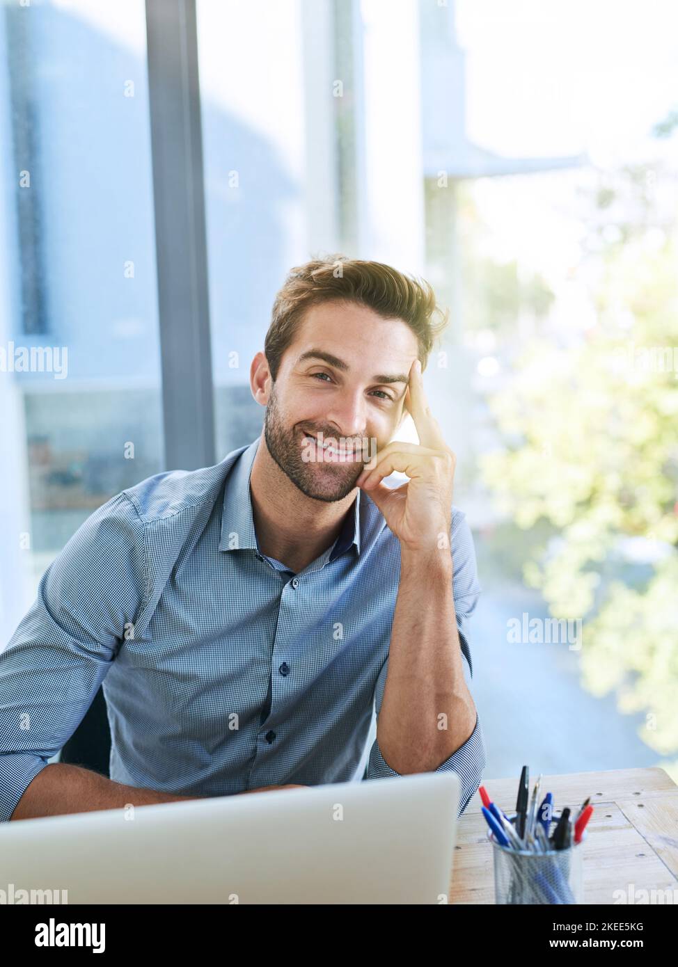 Dedicated to the job. a handsome young businessman in the office Stock ...
