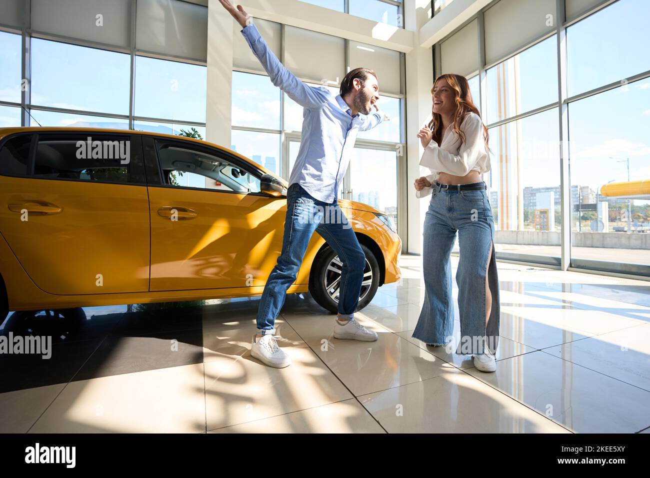 Auto dealership customers celebrating new motorcar purchase Stock Photo ...