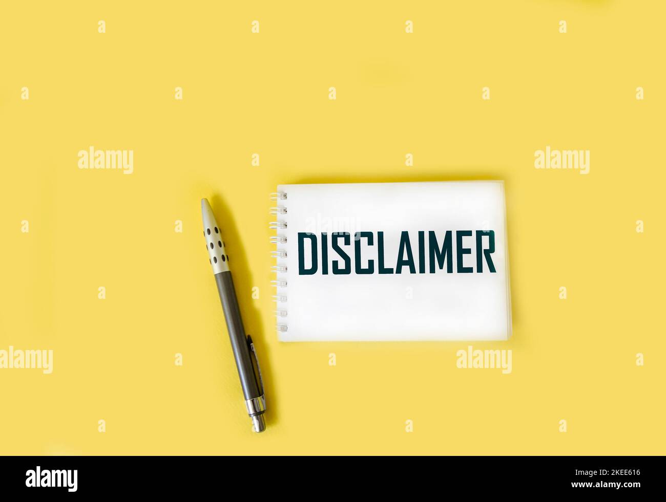 Notepad with text DISCLAIMER on yellow background. business concept ...