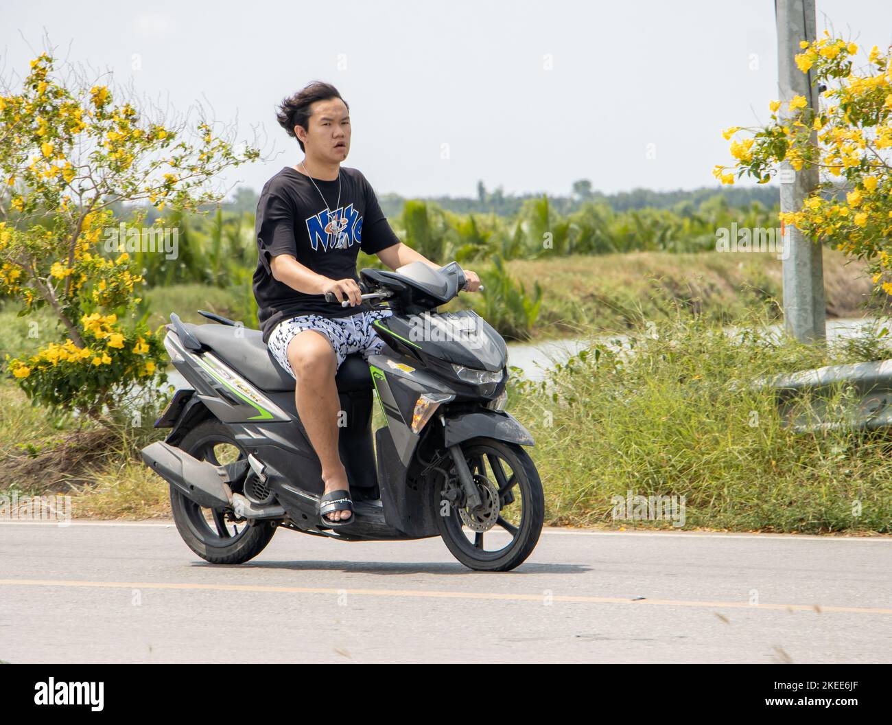 SAMUT PRAKAN, THAILAND, JUNE 01 2022, A man rides on motorcycle at a ...