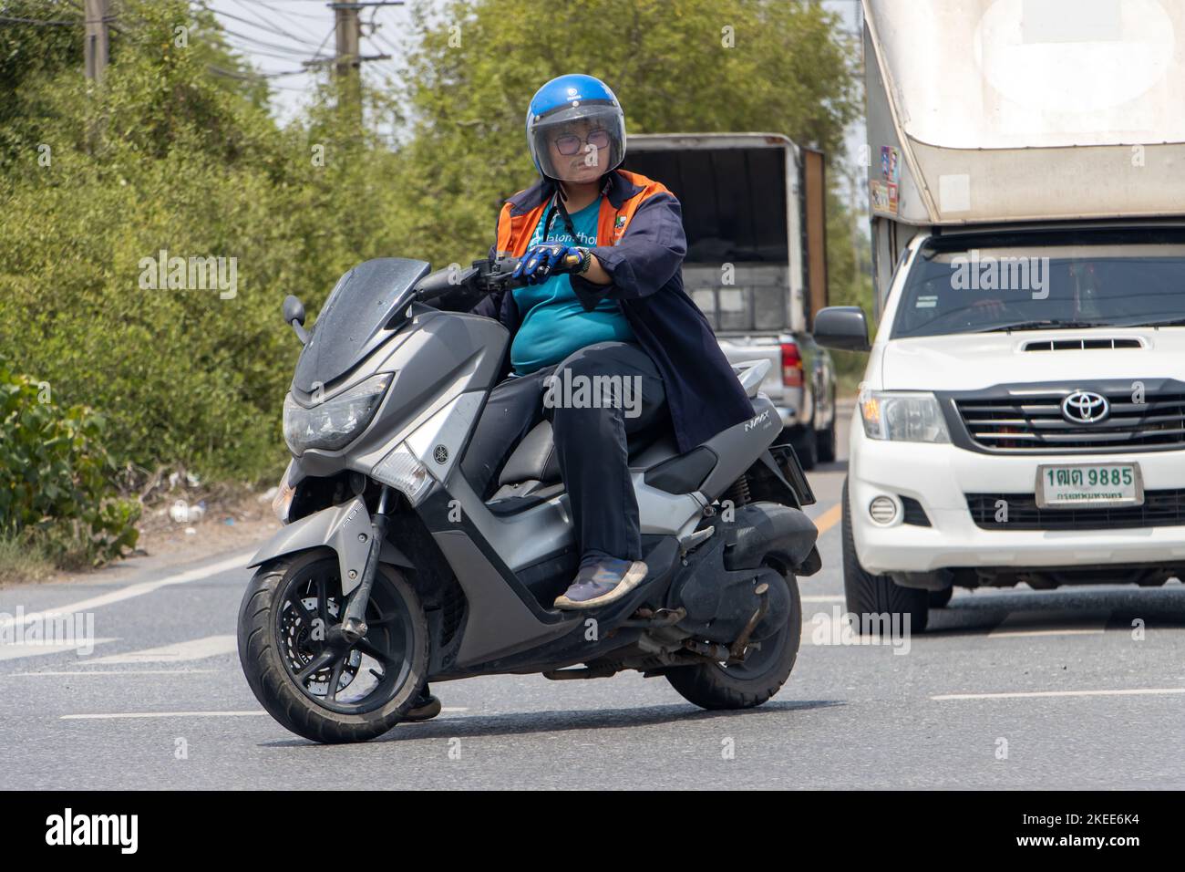BANGKOK, THAILAND, JUNE 01 2022, A man on a motorcycle enters a busy ...