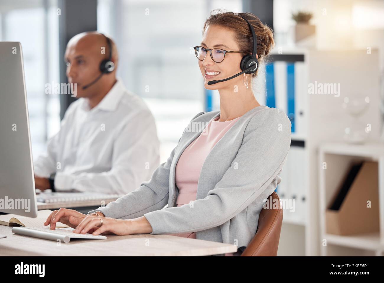 Call center, contact us and worker with a computer for support, help ...