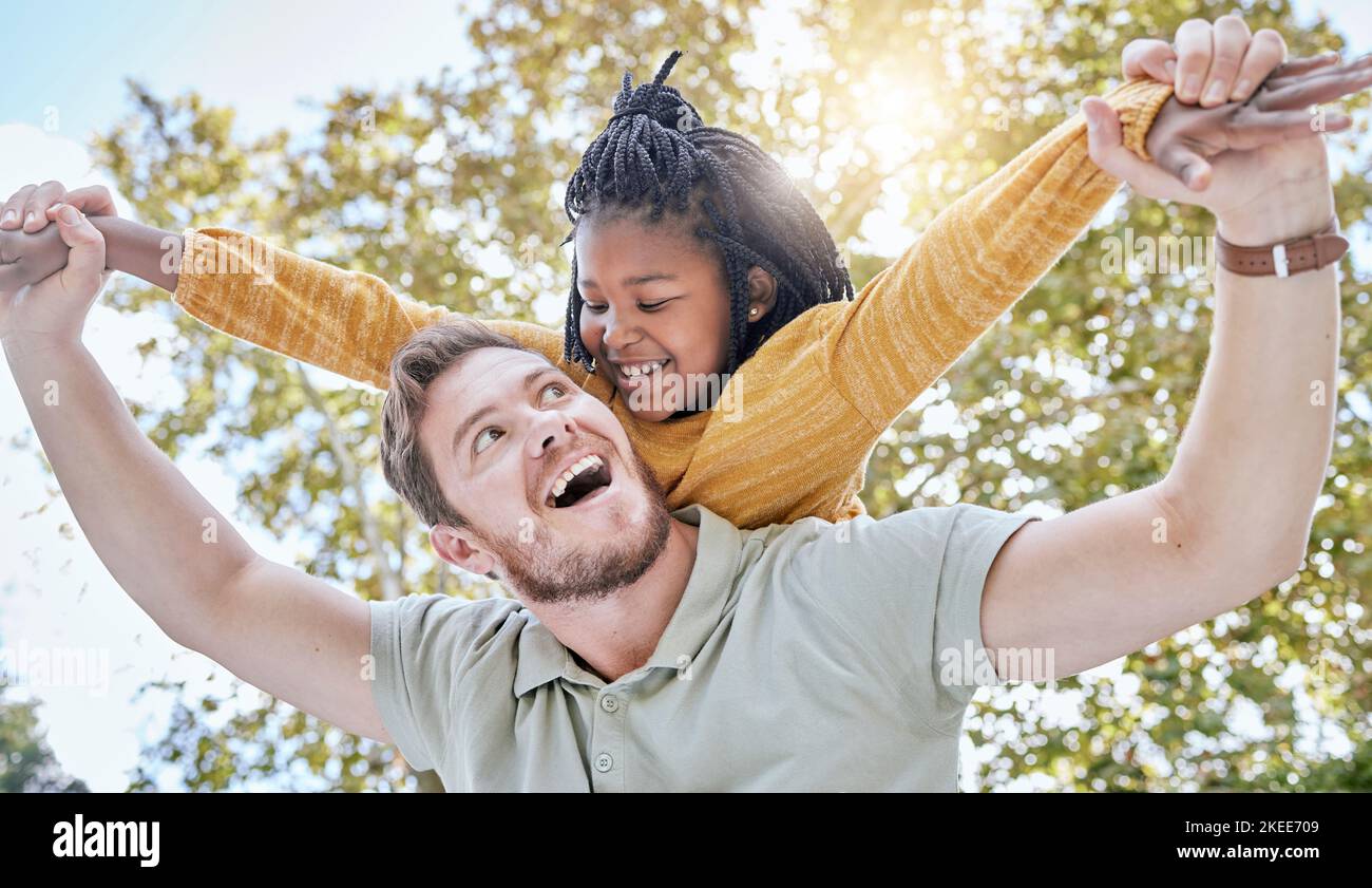 Father, adopted and girl playing flying outside for fun in a nature ...