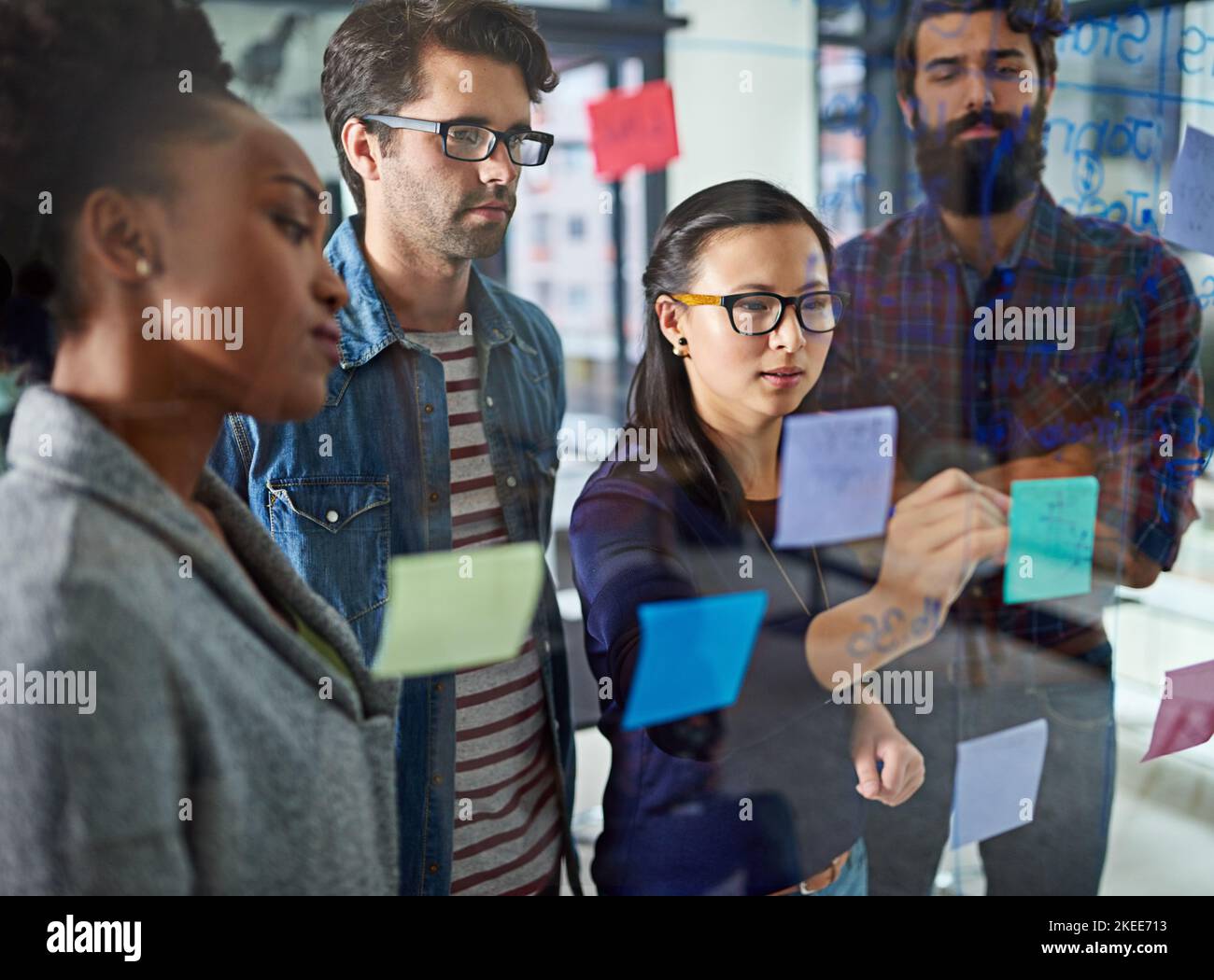 Putting things into perspective for her team. coworkers brainstorming ...