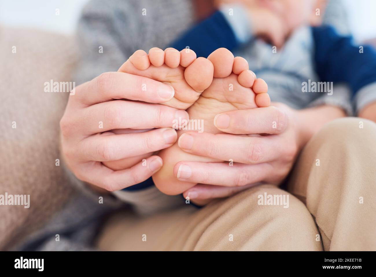 Teeny tiny little toes. Closeup shot of a mother holding her little ...