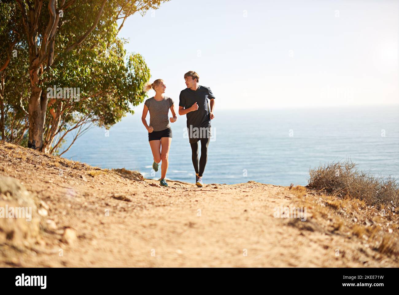 Couples who run together stays together. a young couple trail running ...